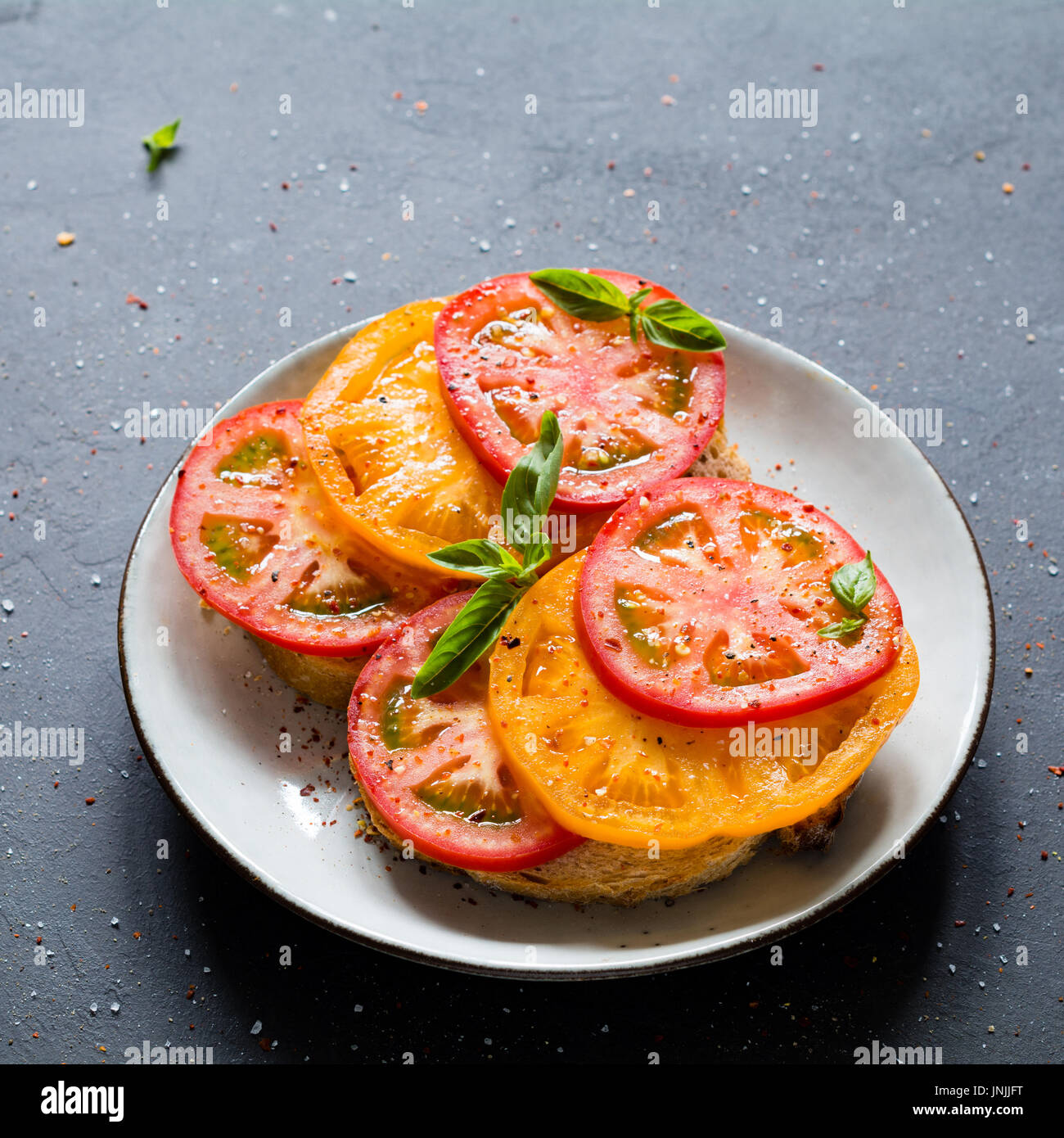 Colorful heirloom tomato sliced Stock Photo - Alamy