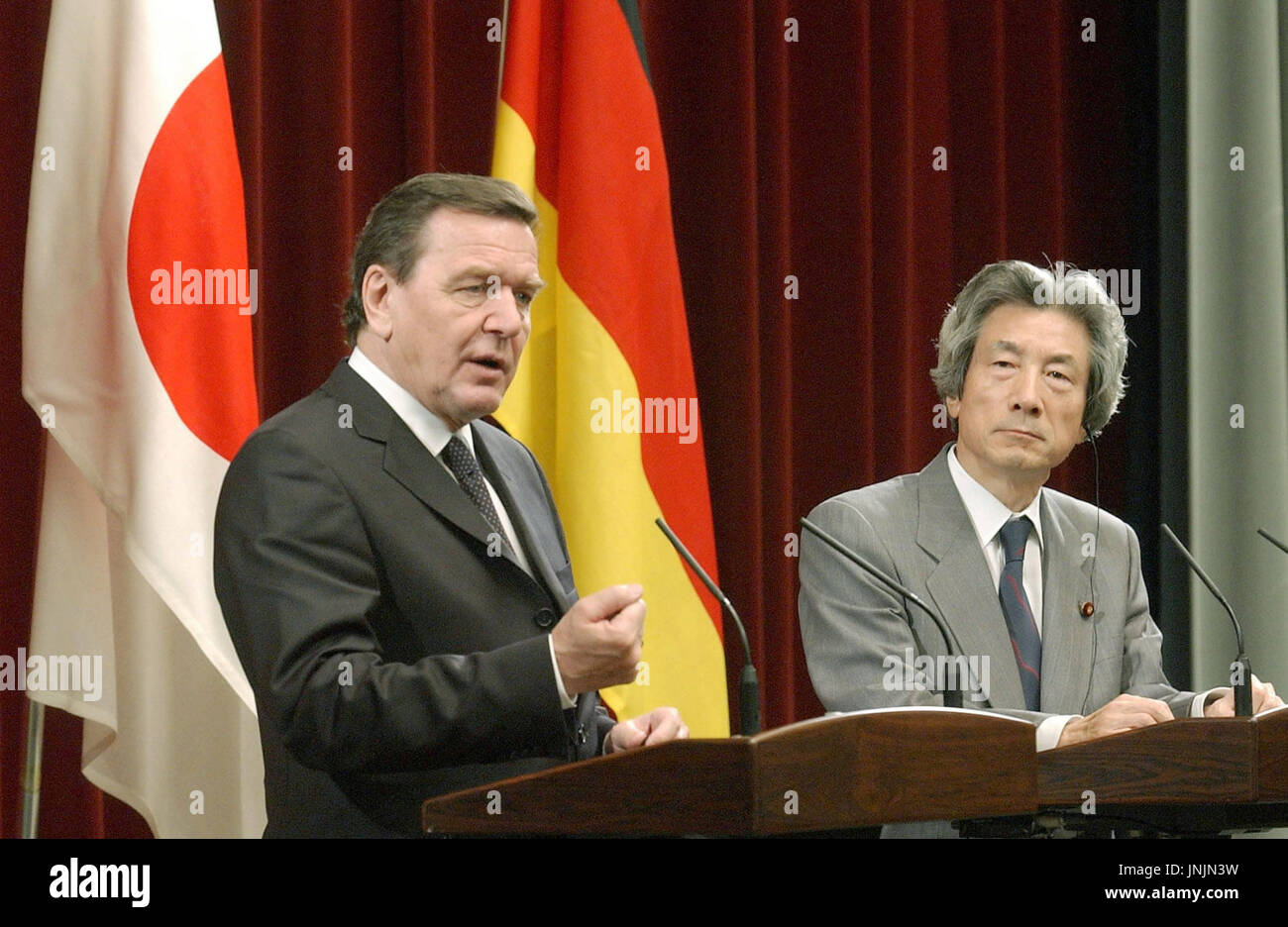 TOKYO, Japan - German Chancellor Gerhard Schroeder (L) speaks as ...