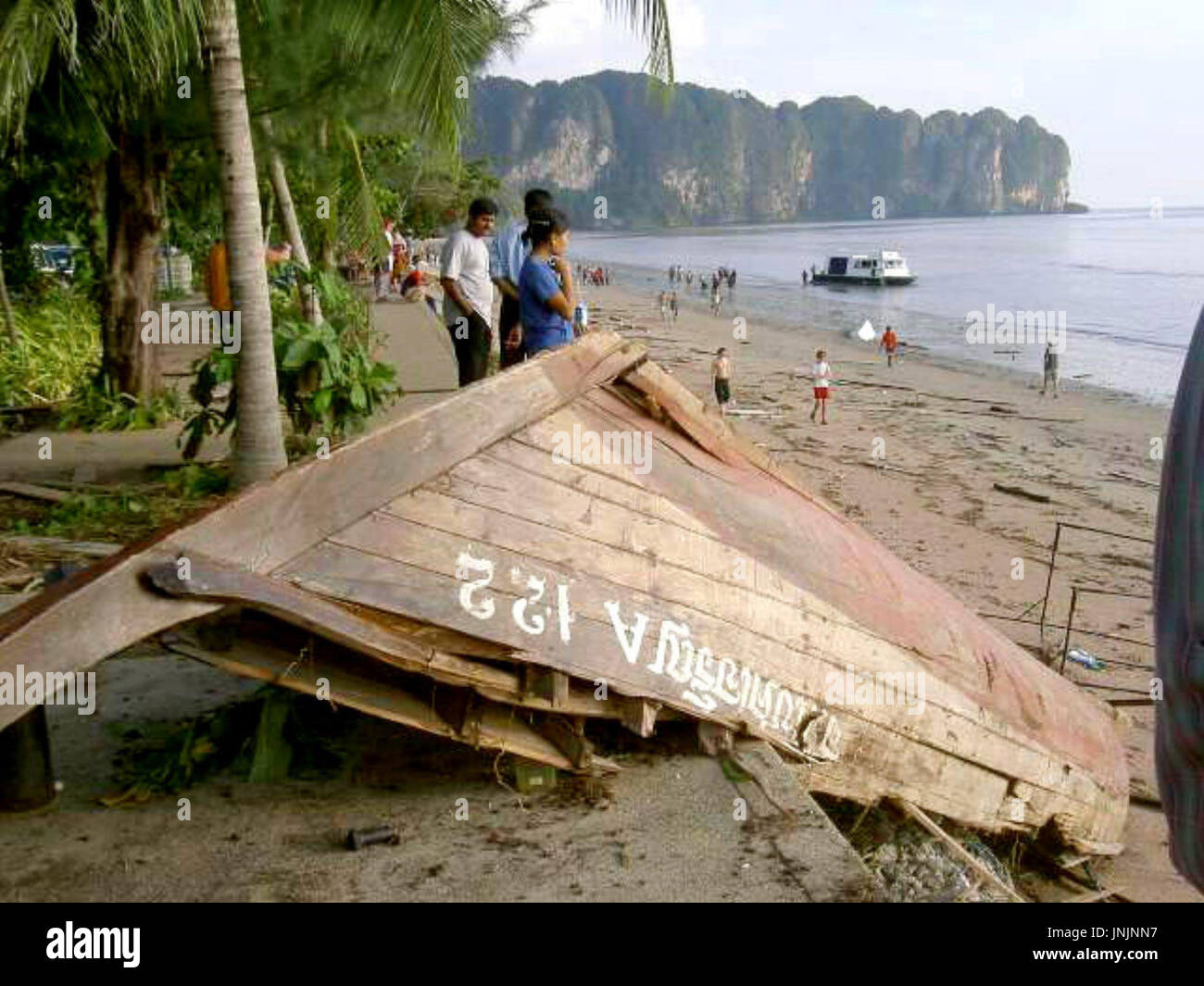 BANGKOK, Thailand - Locals stand on a beach in Phangnga Province in ...