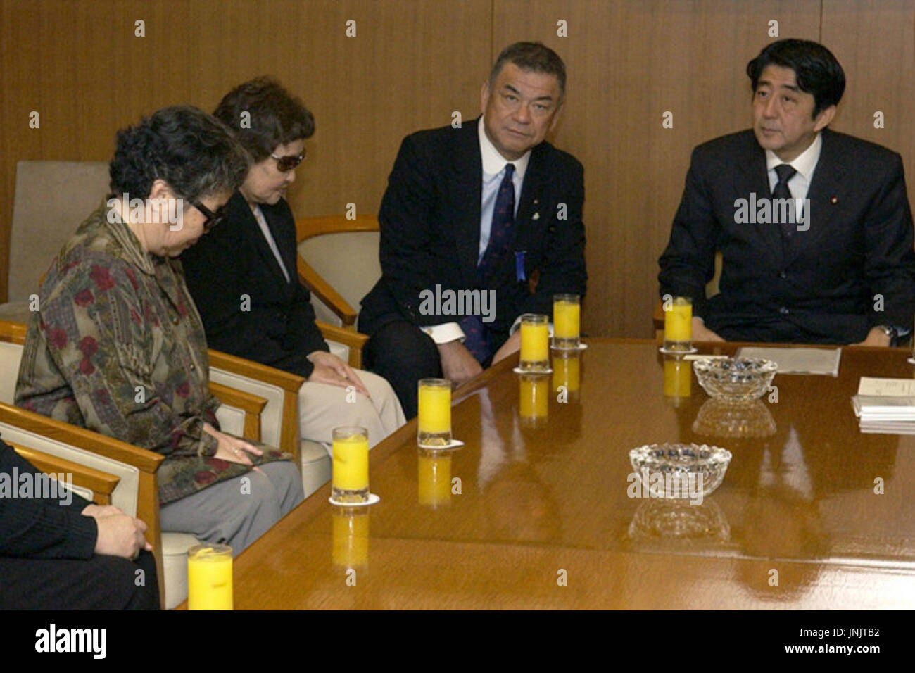 TOKYO, Japan - Two unidentified Japanese defectors (seated on the left ...