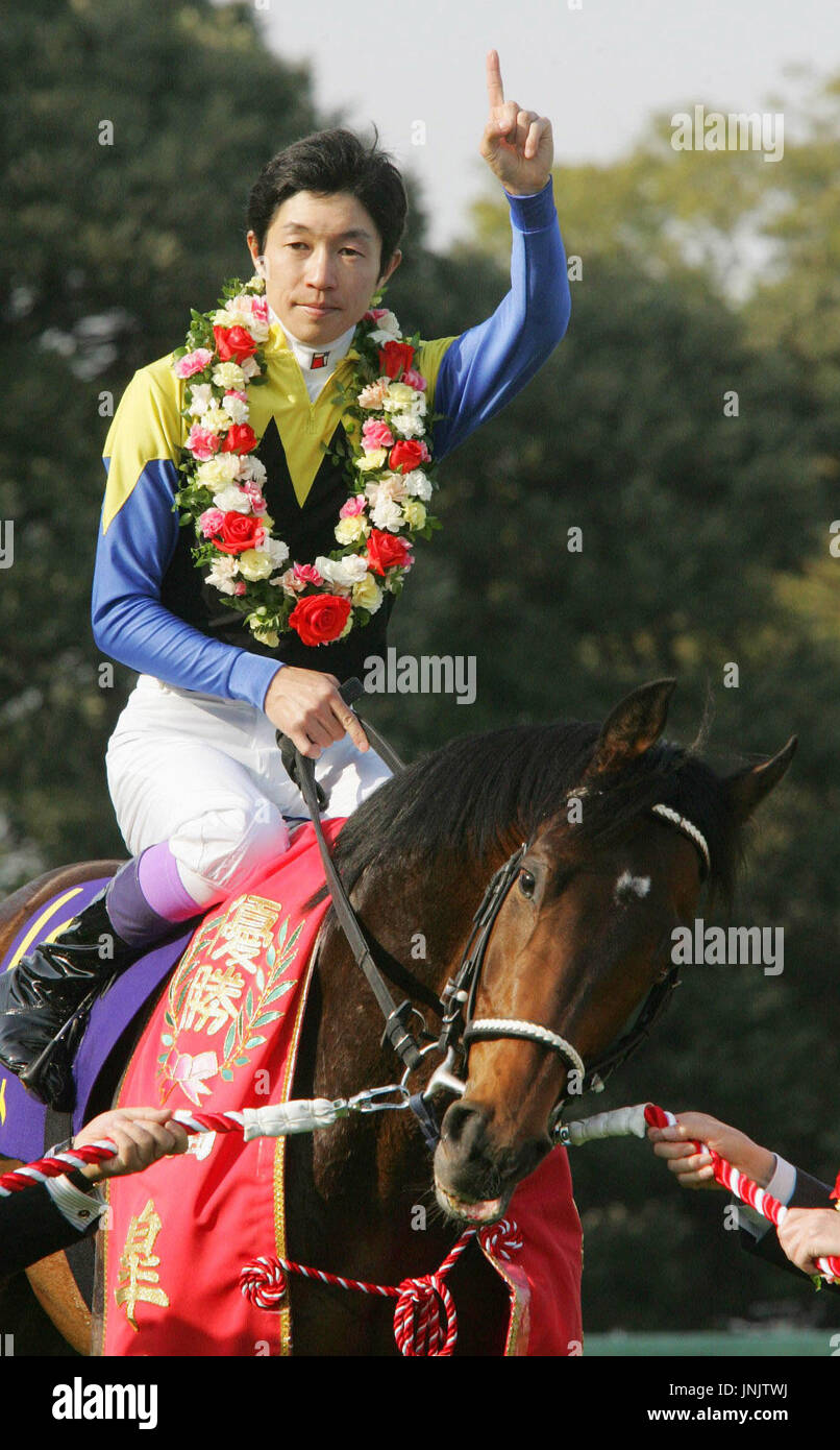 FUNABASHI, Japan - Jockey Yutaka Take waves to fans after guiding ...