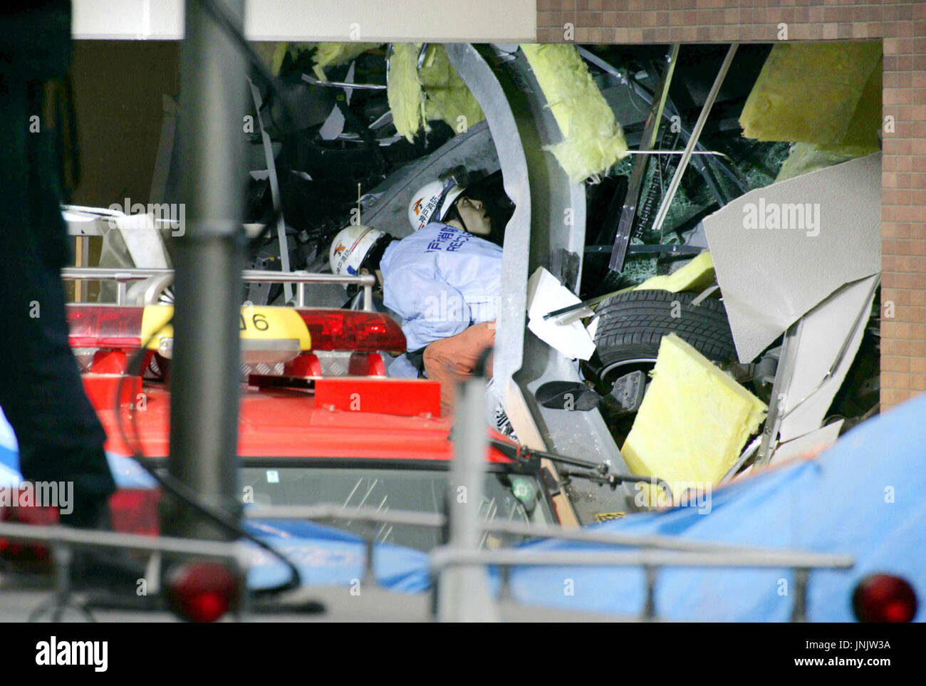 AMAGASAKI, Japan - Firefighters are at work to rescue survivors from one of two commuter train ...