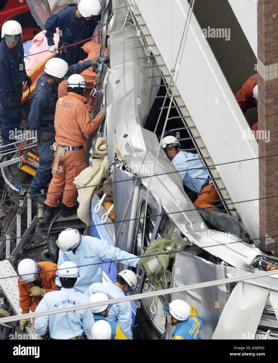 AMAGASAKI, Japan - Firefighters work hard to rescue survivors from one of first two commuter ...