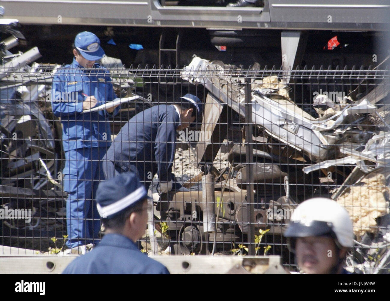 AMAGASAKI, Japan - Police officers investigate a carriage of a JR West train on April 27 at the ...