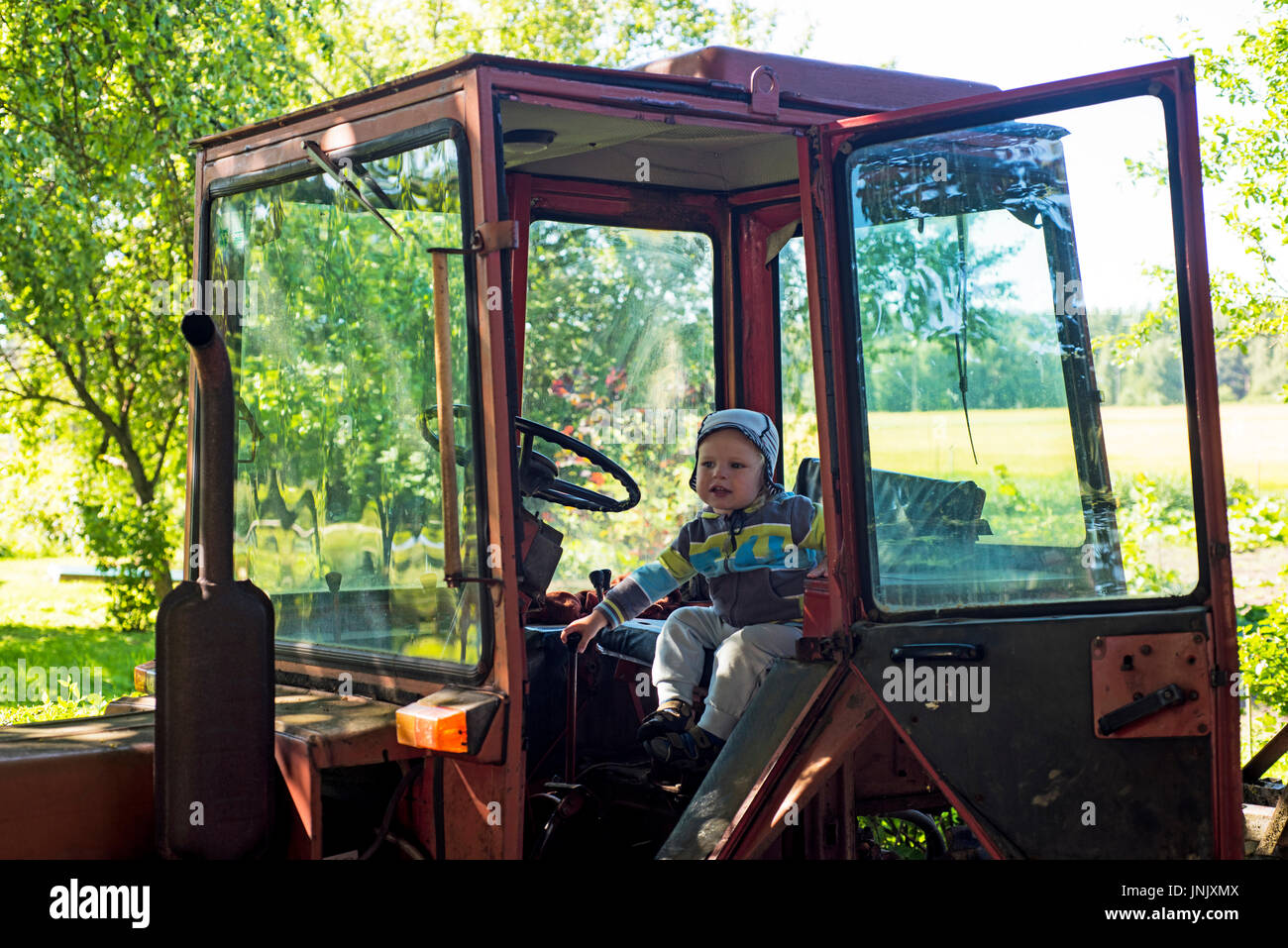 Boy farming in field with tractor hi-res stock photography and images ...