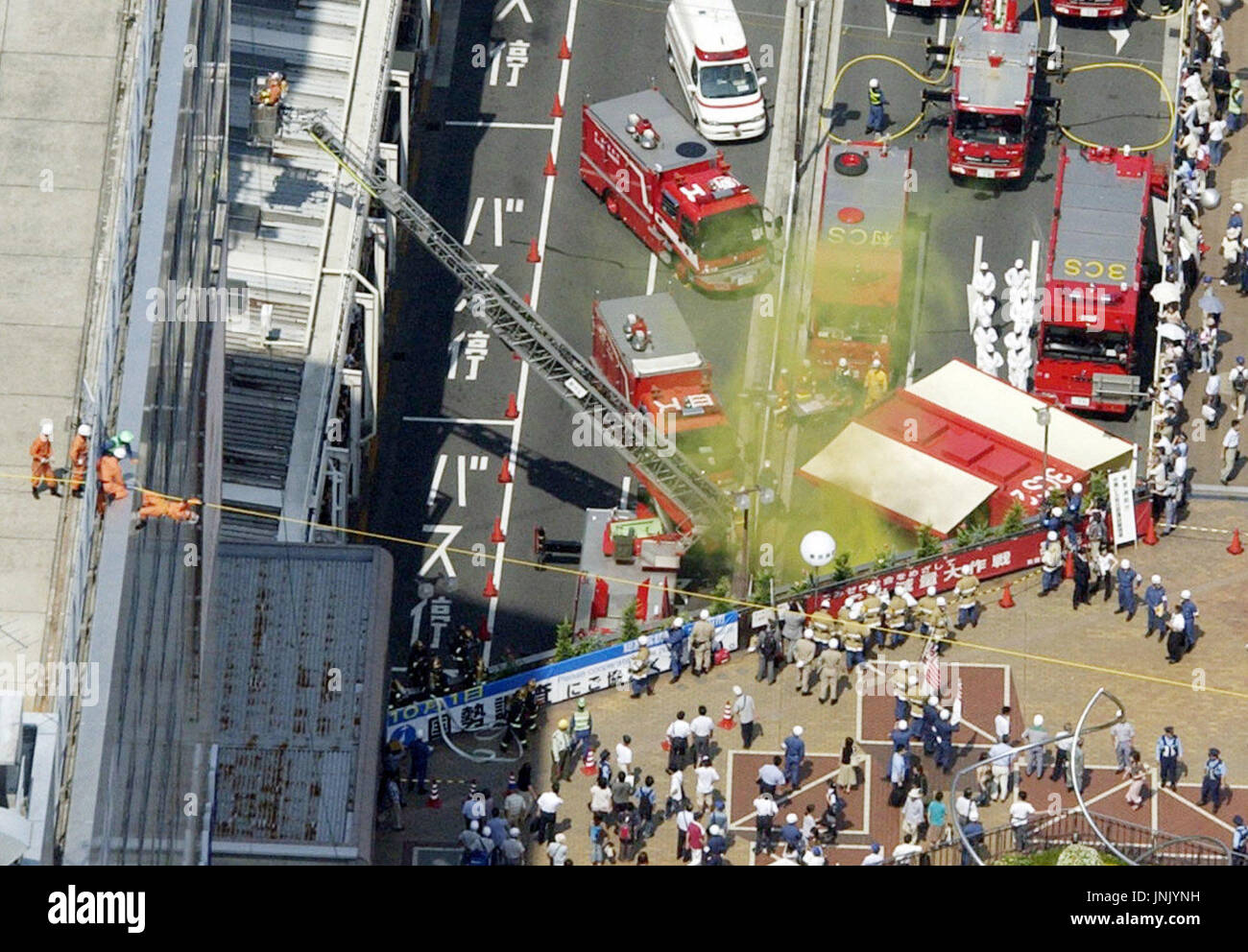 TOKYO, Japan - Firefighters rescue people using ropes and ladder trucks ...