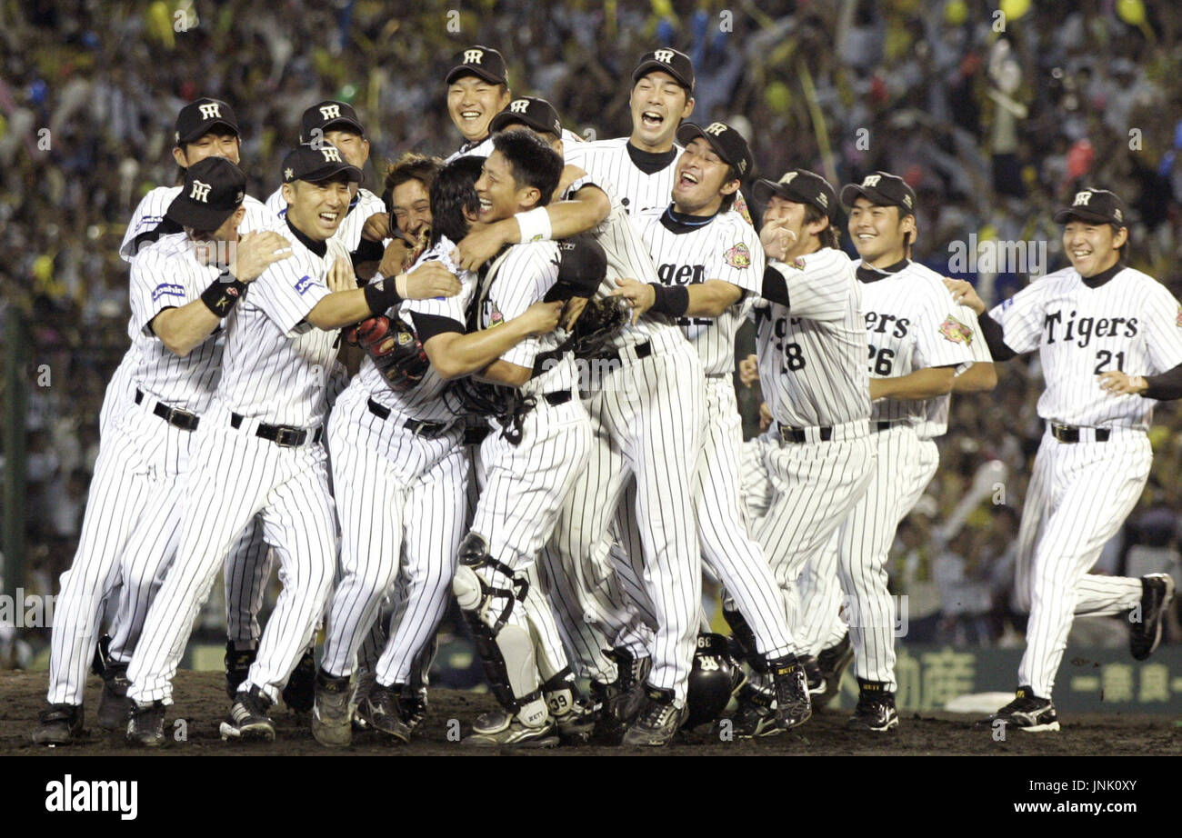 KOSHIEN, Japan - Jubilant Hanshin Tigers baseball players hug each ...