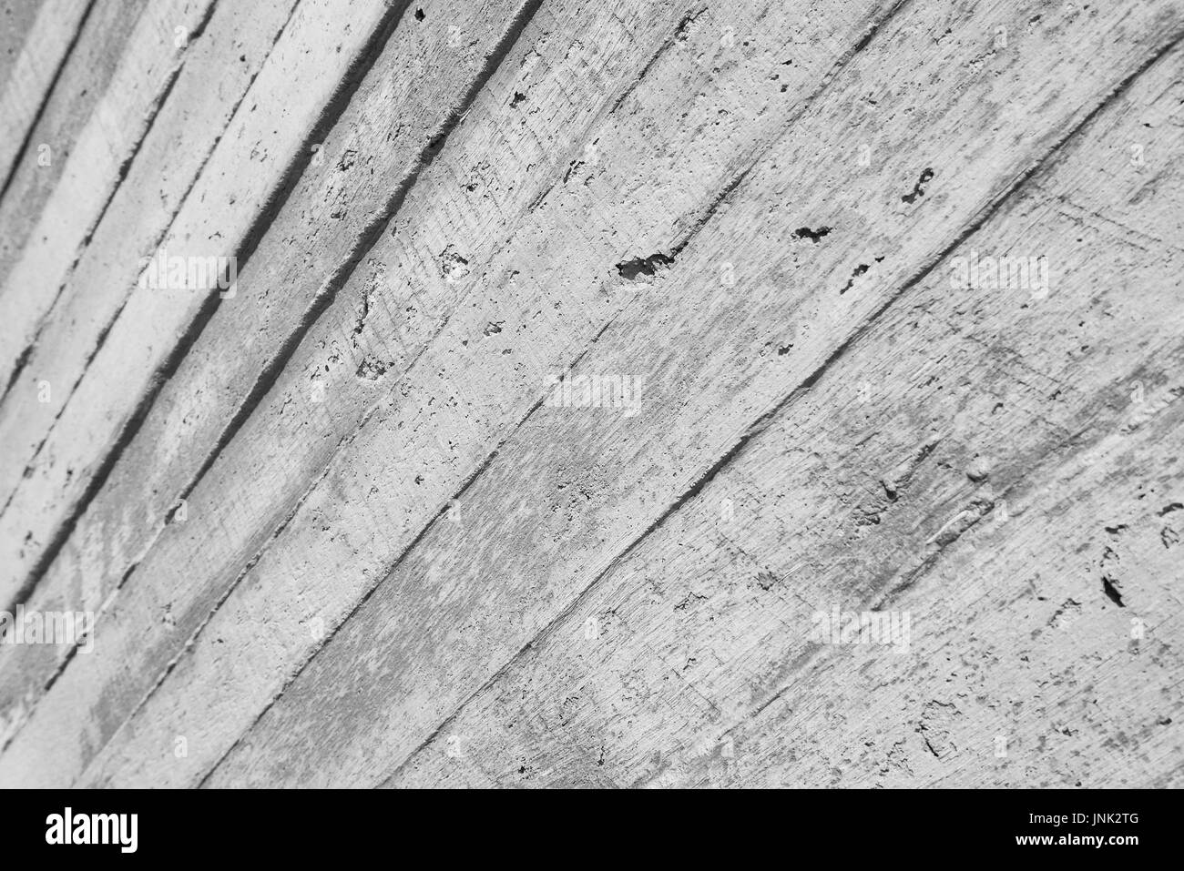 texture of wooden formwork stamped on a raw concrete wall as background ...