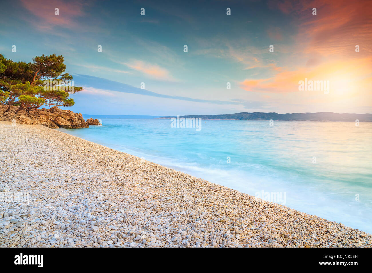 Amazing colorful sunset over the beach, near Brela, Makarska riviera ...