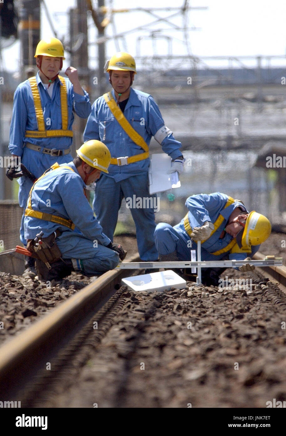 ITAMI, Japan - West Japan Railway Co. workers install an advanced type of Automatic Train Stop ...