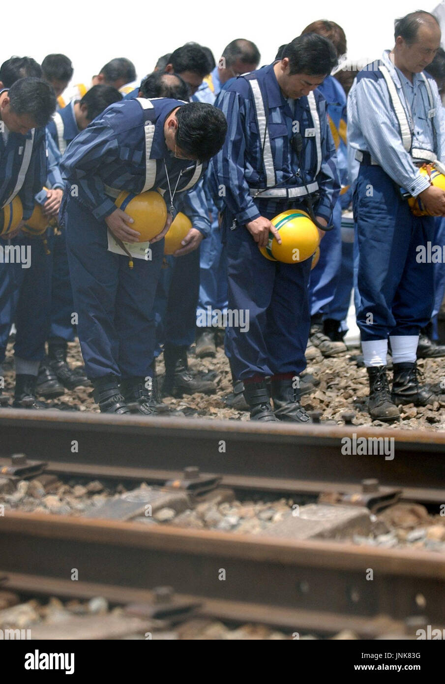 AMAGASAKI, Japan - Workers pray for the victims of the April 25 fatal train derailment on West ...