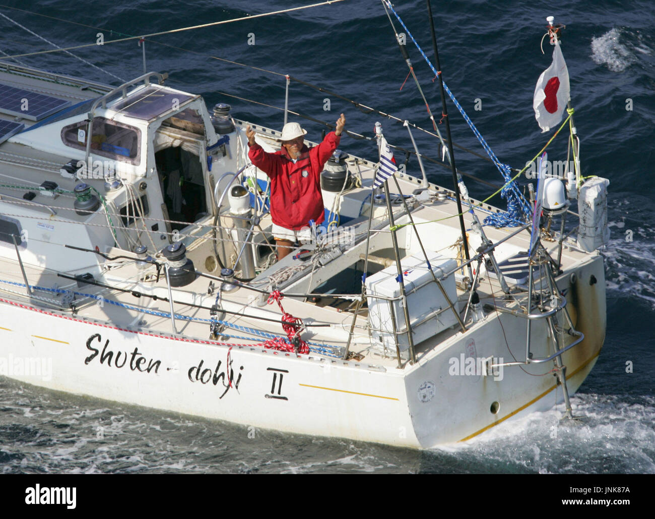 YOKOSUKA, Japan - Japanese adventurer Minoru Saito throws up his arms ...