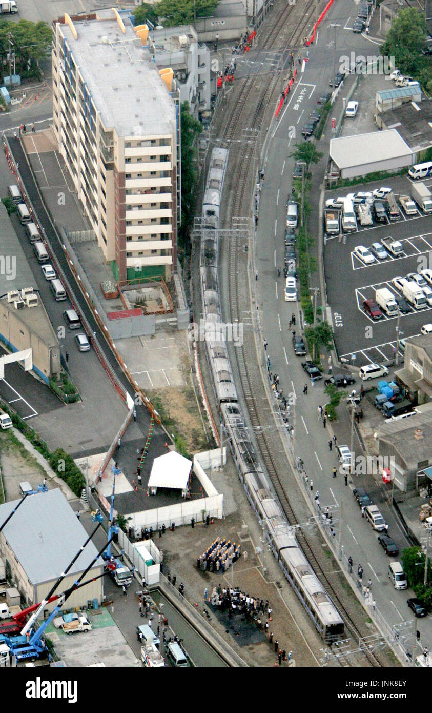 AMAGASAKI, Japan - A West Japan Railway Co. train passes the April 25 fatal derailment accident ...