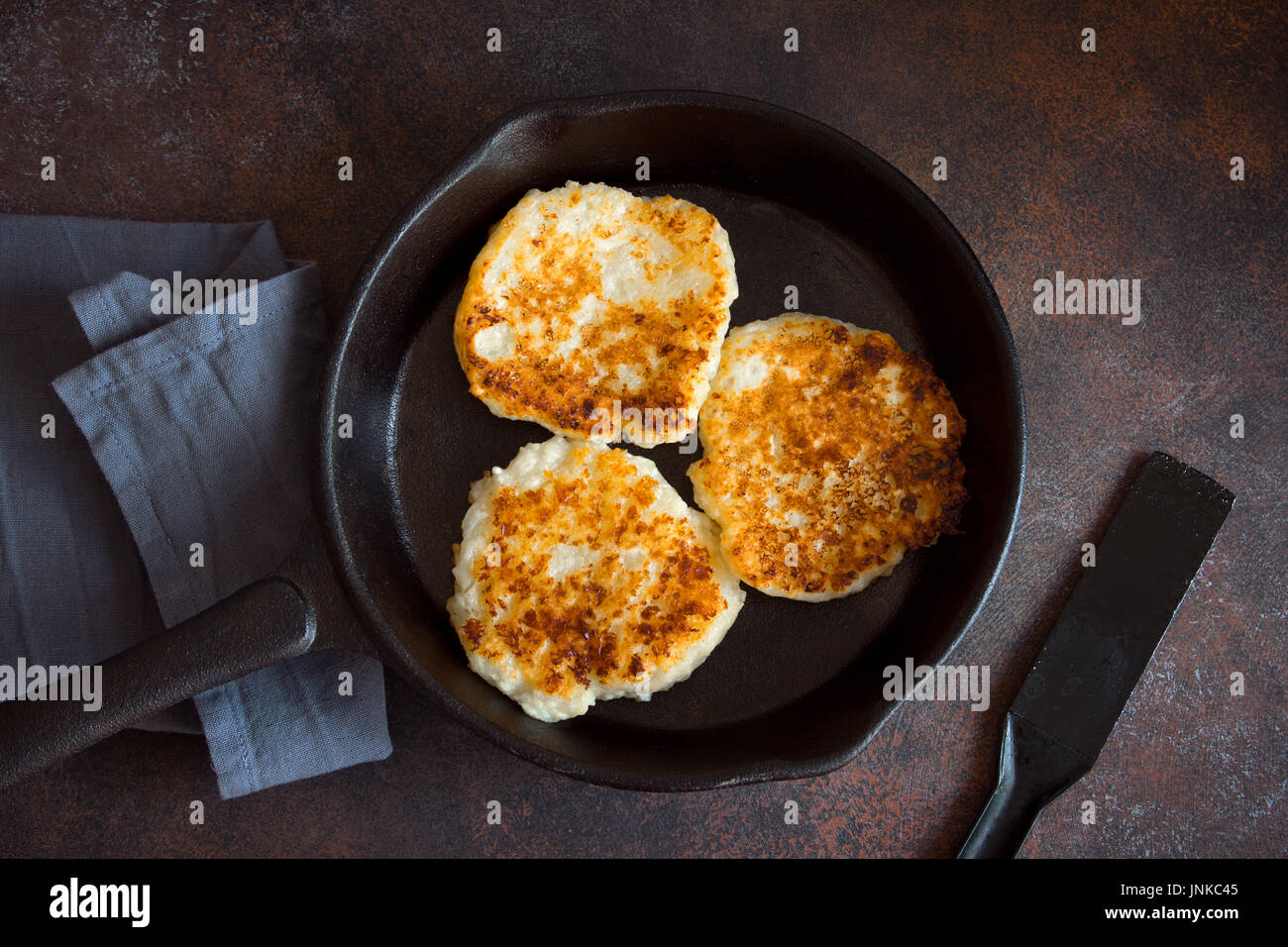 Rustic homemade curd pancakes in cast iron pan for breakfast, country ...