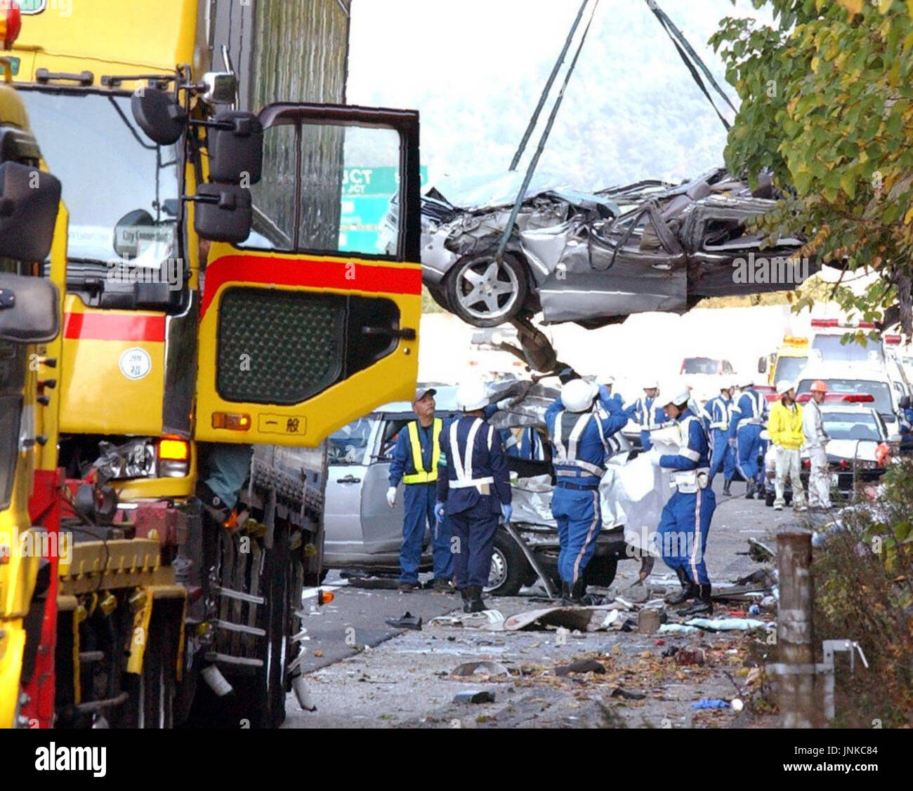 OTSU, Japan - Police and workers remove the wreckage of a car damaged ...