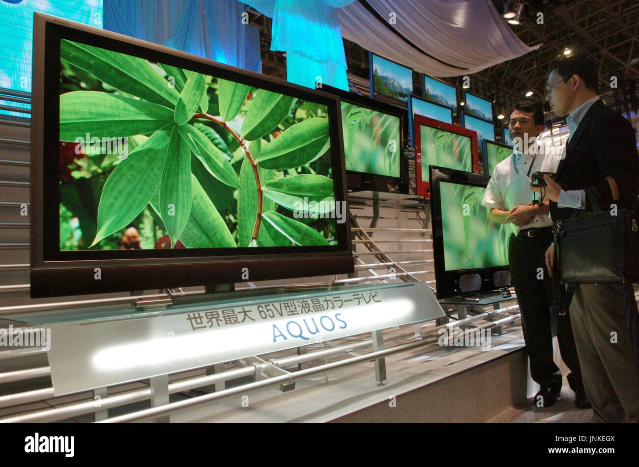 TOKYO, Japan - Visitors look at Sharp Corp.'s Aguos television, which ...