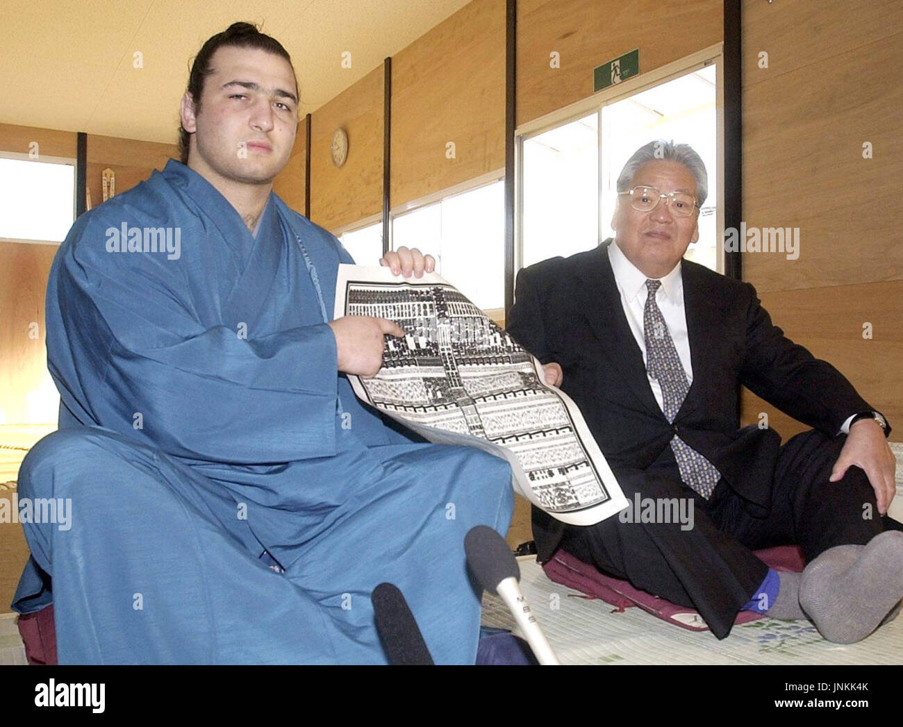 OSAKA, Japan - Bulgarian sumo wrestler Kotooshu (L) holds up a sumo ...
