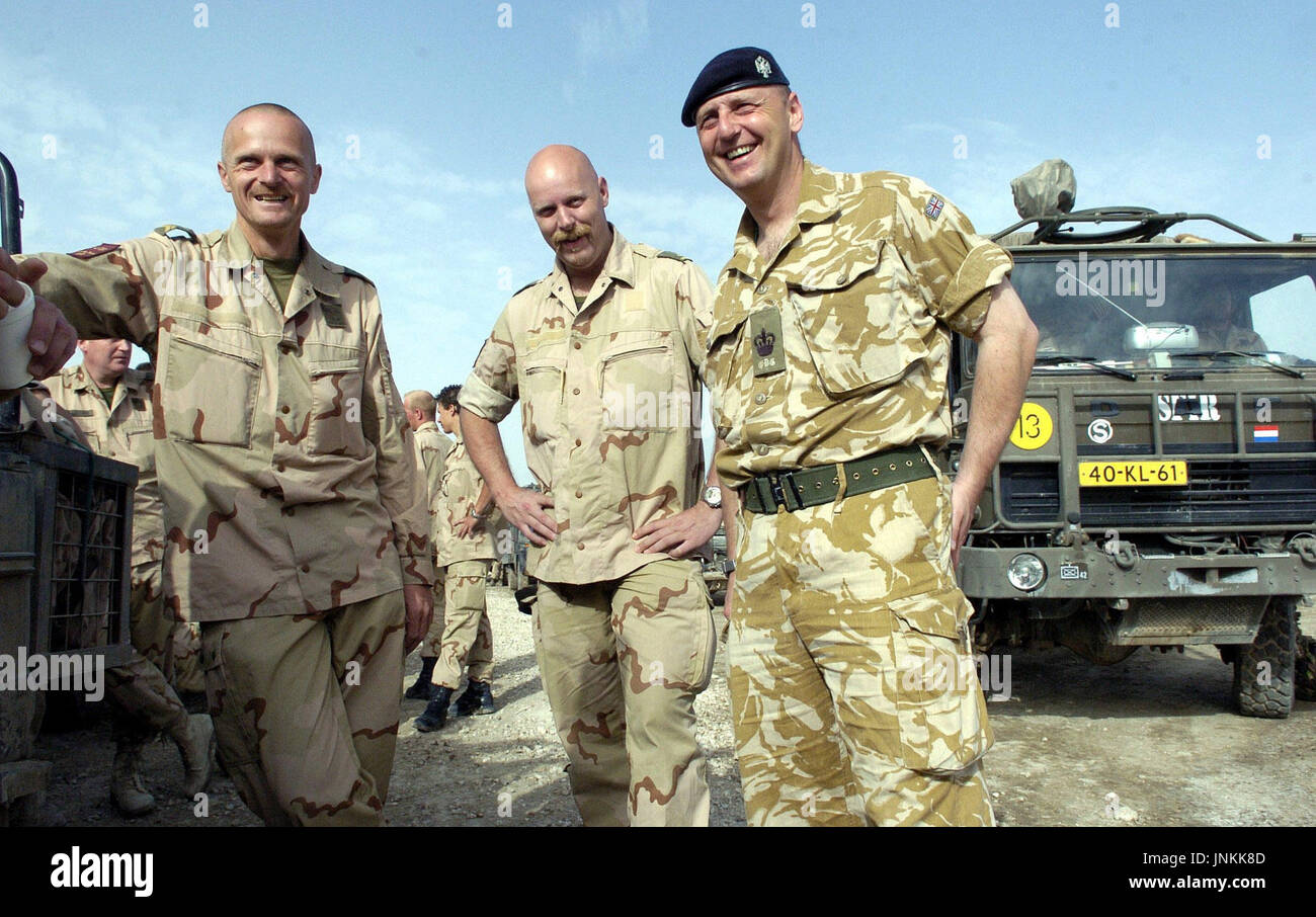 SAMAWAH, Iraq - A British soldier (R) chats with Dutch soldiers at Camp ...