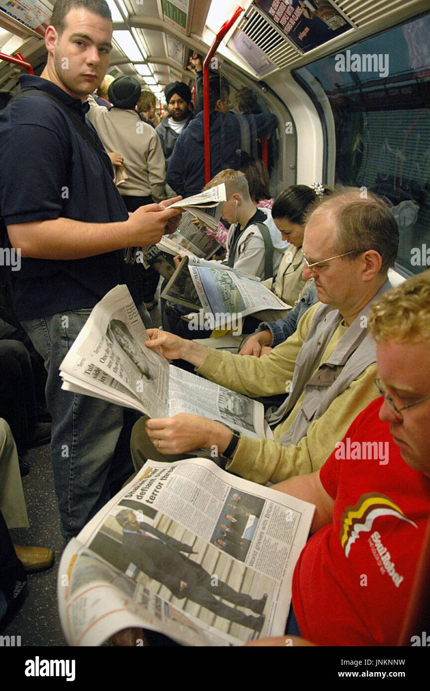 LONDON, England - Commuters read their newspaper in a London ...