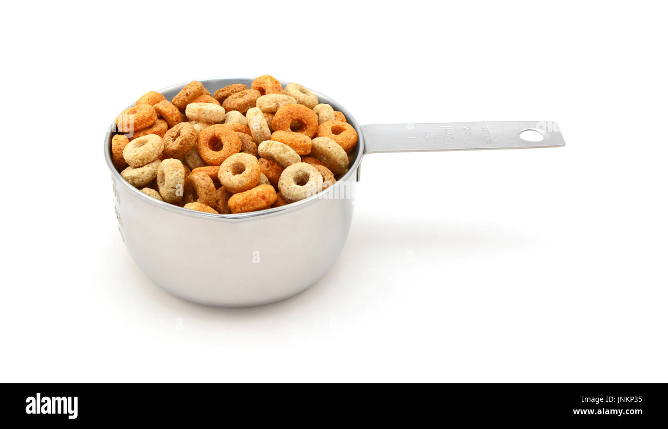 Multigrain hoops breakfast cereal in an American cup measure, isolated ...
