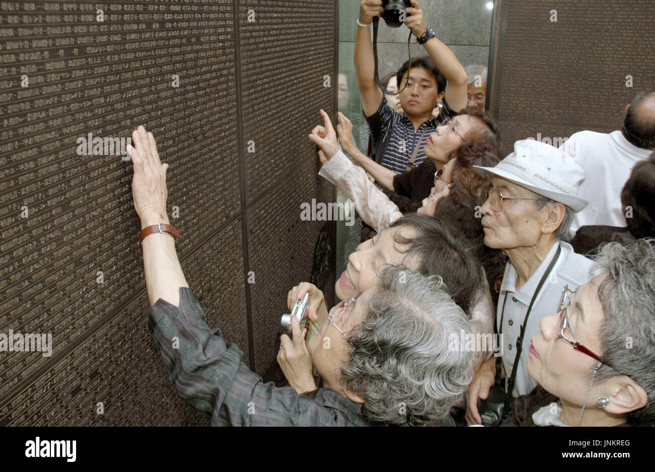 OSAKA, Japan - People look at the names of their relatives and friends ...