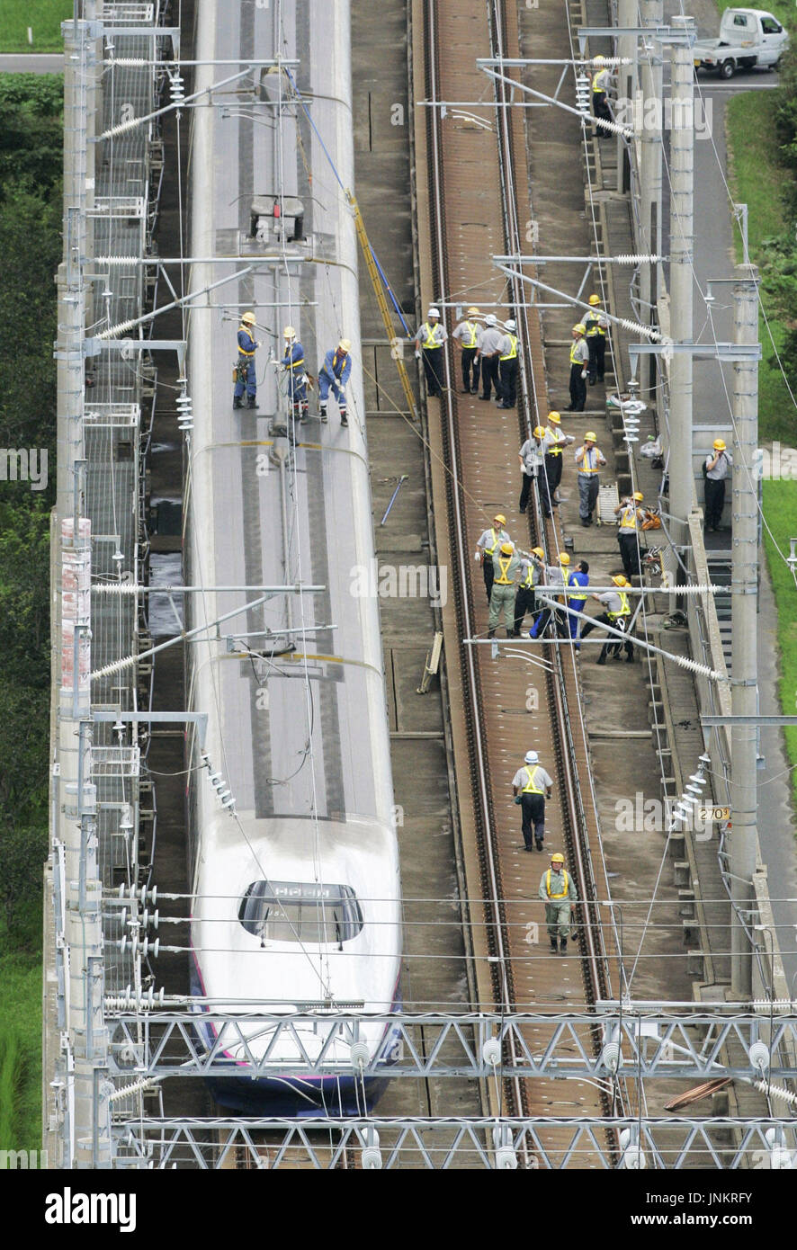 SENDAI, Japan - Workers conduct repairs on a Tohoku Shinkansen Line ...