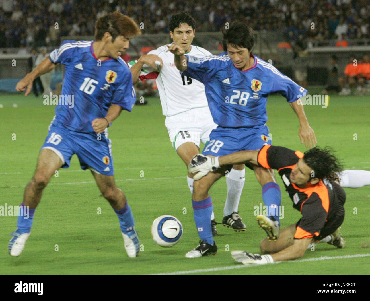 YOKOHAMA, Japan - Iran goalkeeper Ebrahim Mirzapour (R) and midfielder ...