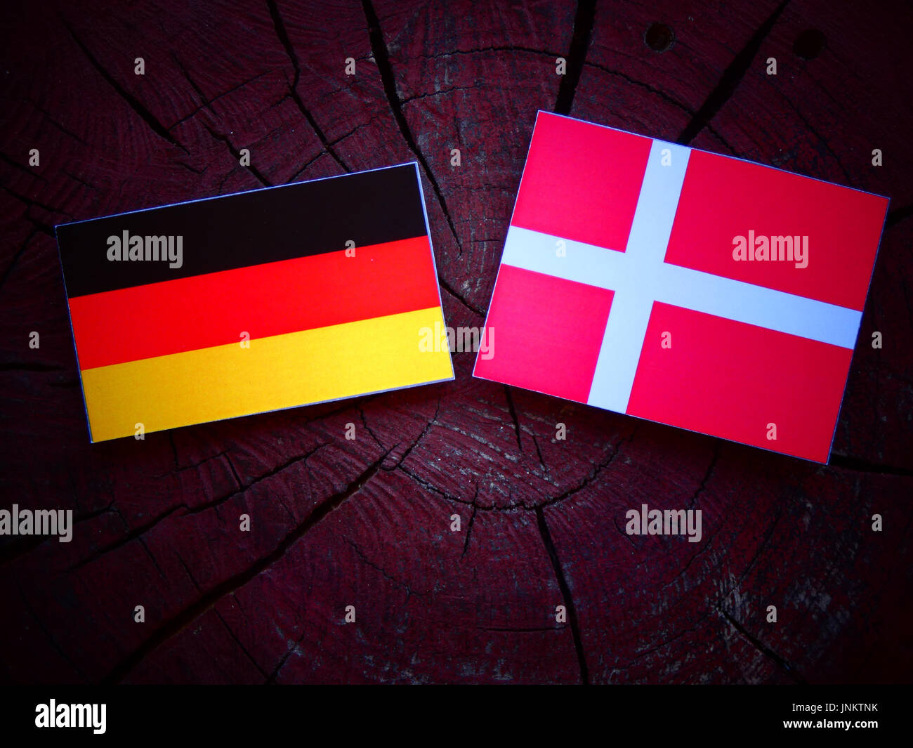 German flag with Danish flag on a tree stump isolated Stock Photo - Alamy