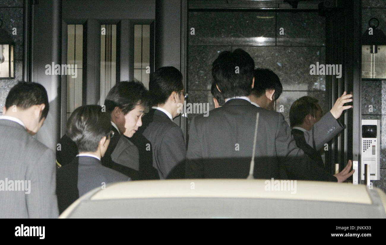 TOKYO, Japan - Police investigators enter the home of Takeshi Uchikawa ...