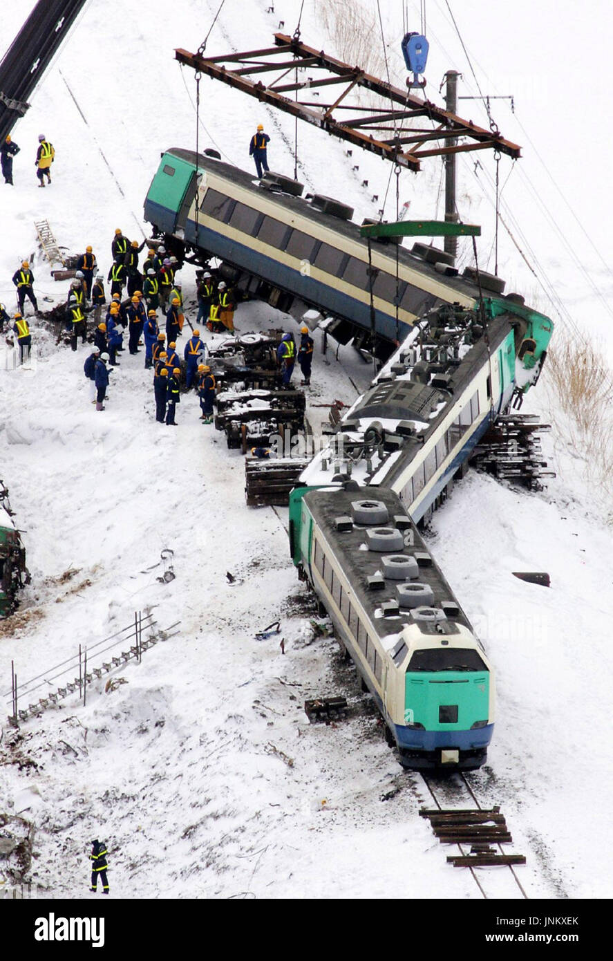 SAKATA, Japan - Workers remove the cars of the express train Inaho No ...