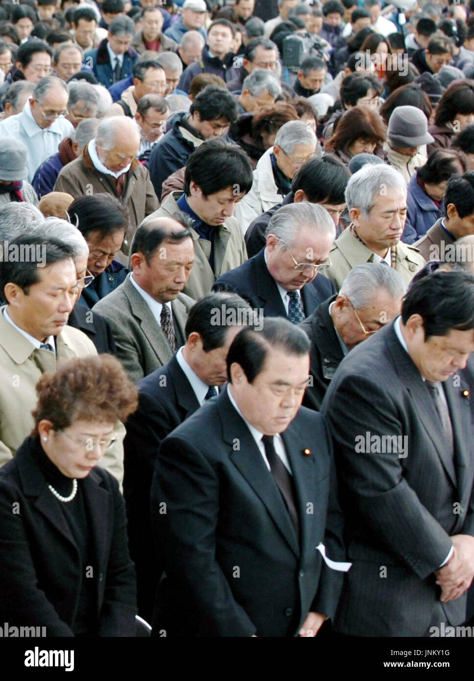 KOBE, Japan - People observe a moment of silence during a ceremony Jan ...