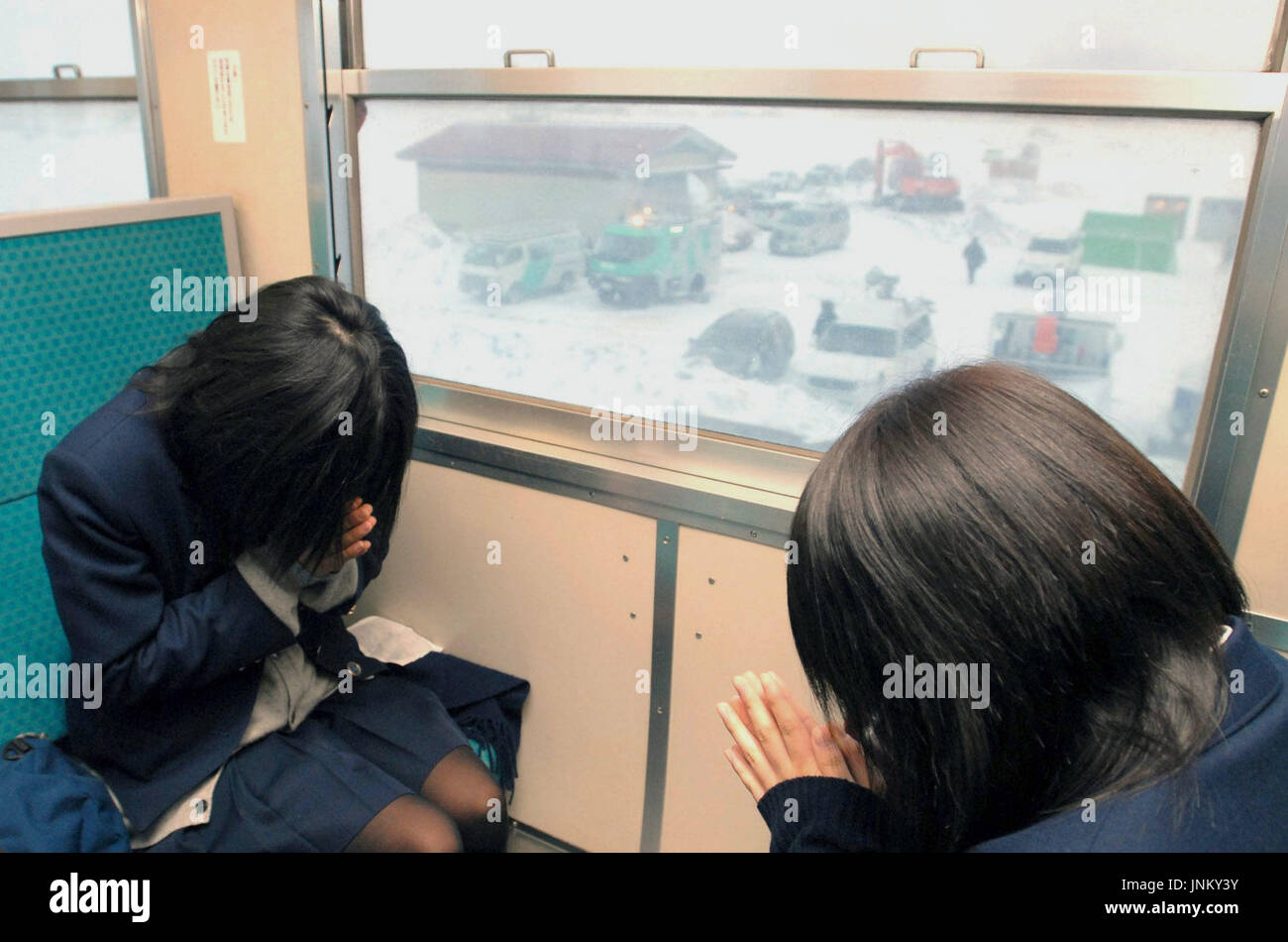 YAMAGATA, Japan - Two high school students offer silent prayers aboard ...