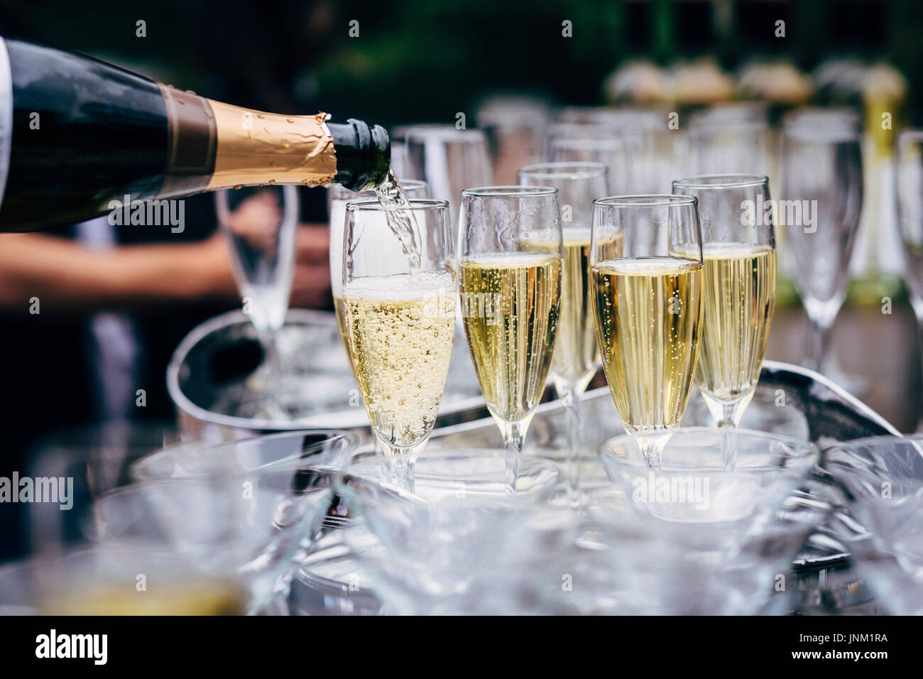 Pouring Champagne to empty champagne glass. Social event Stock Photo ...