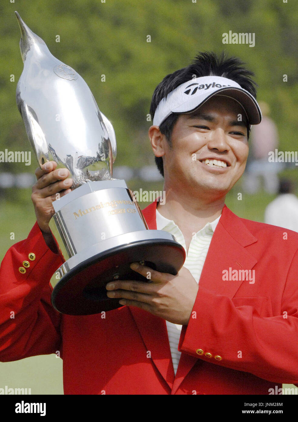 TAMANO, Japan - Toshinori Muto holds up the trophy after winning his ...
