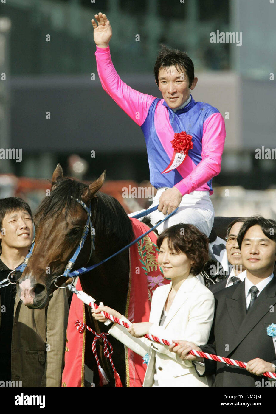 TOKYO, Japan - Jockey Mamoru Ishibashi aboard Meisho Samson waves after ...