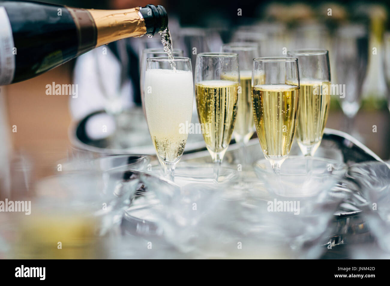 Pouring Champagne to empty champagne glass. Social event Stock Photo ...