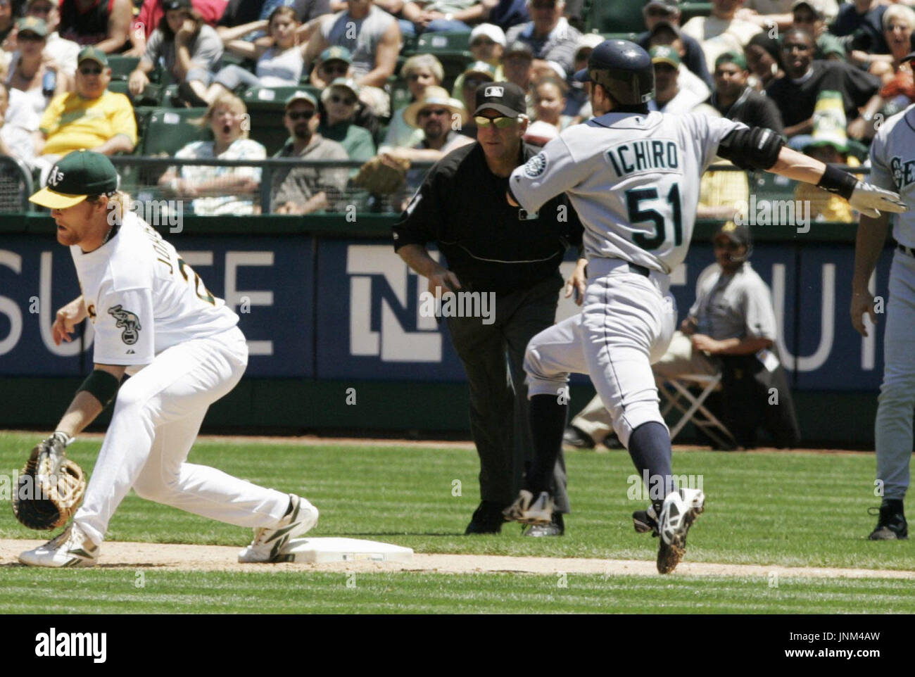 OAKLAND, United States - Ichiro Suzuki (51) dashes to first base on his ...