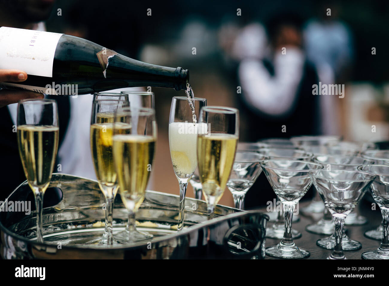 Pouring Champagne to empty champagne glass. Social event Stock Photo ...