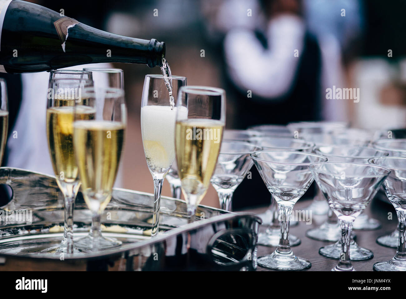 Pouring Champagne to empty champagne glass. Social event Stock Photo ...
