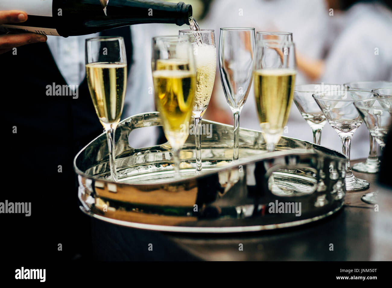 Pouring Champagne to empty champagne glass. Social event Stock Photo ...