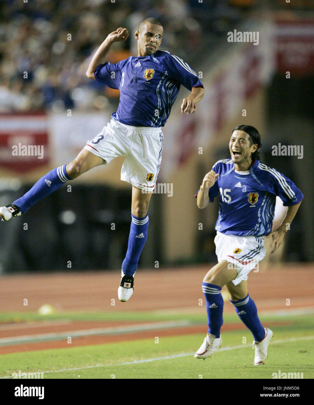 TOKYO, Japan - Japan defender Alessandro Santos, followed by teammate ...