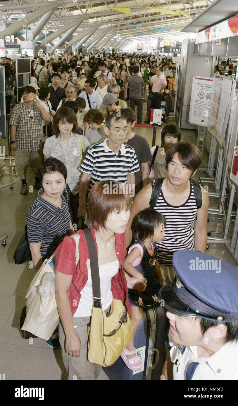 OSAKA, Japan - Travelers form a long line before leaving Kansai airport ...