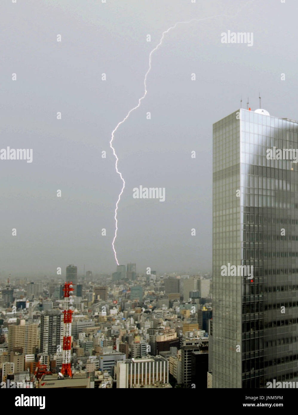 TOKYO, Japan - A lightning bolt strikes Tokyo on Aug. 12, while a ...