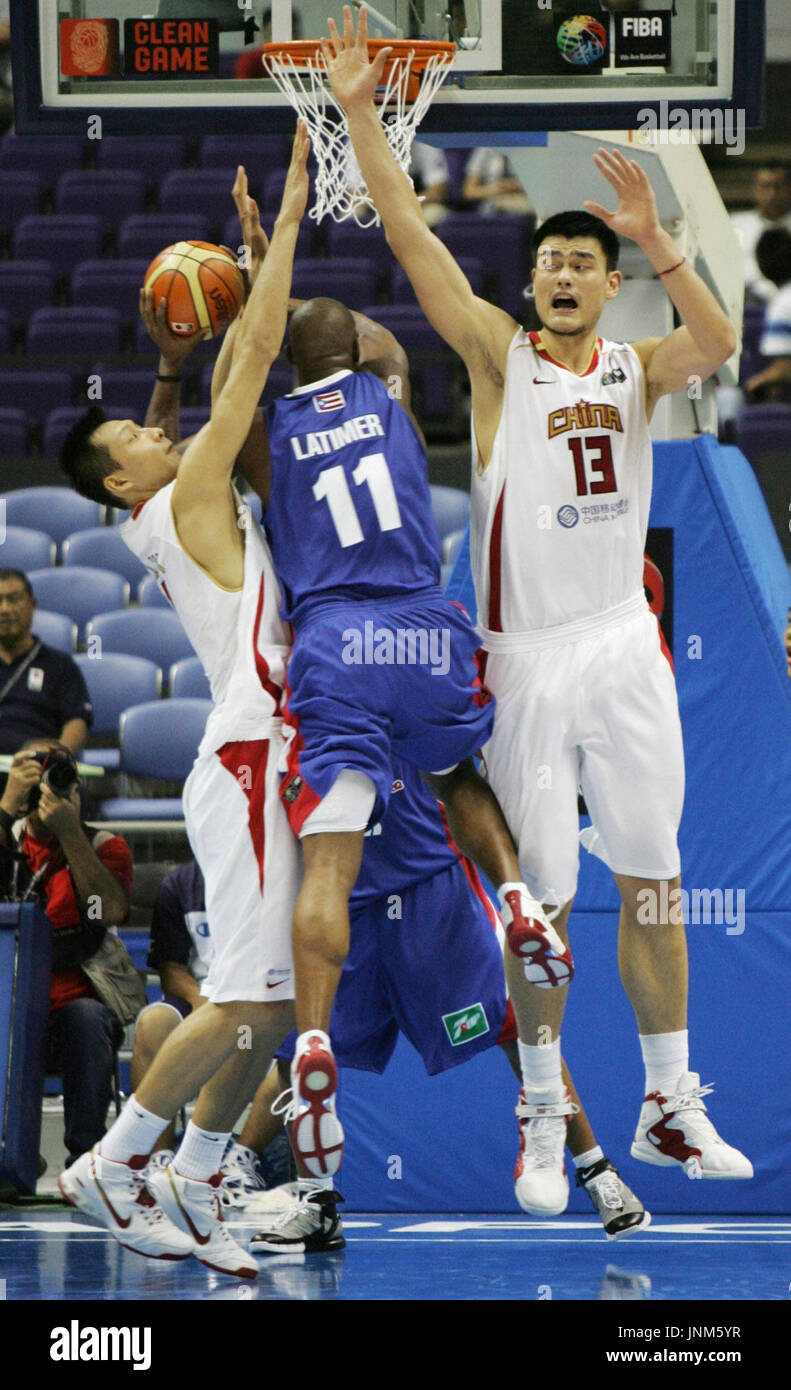 SAPPORO, Japan - China's Yao Ming (R) blocks a shot by Puerto Rico's ...