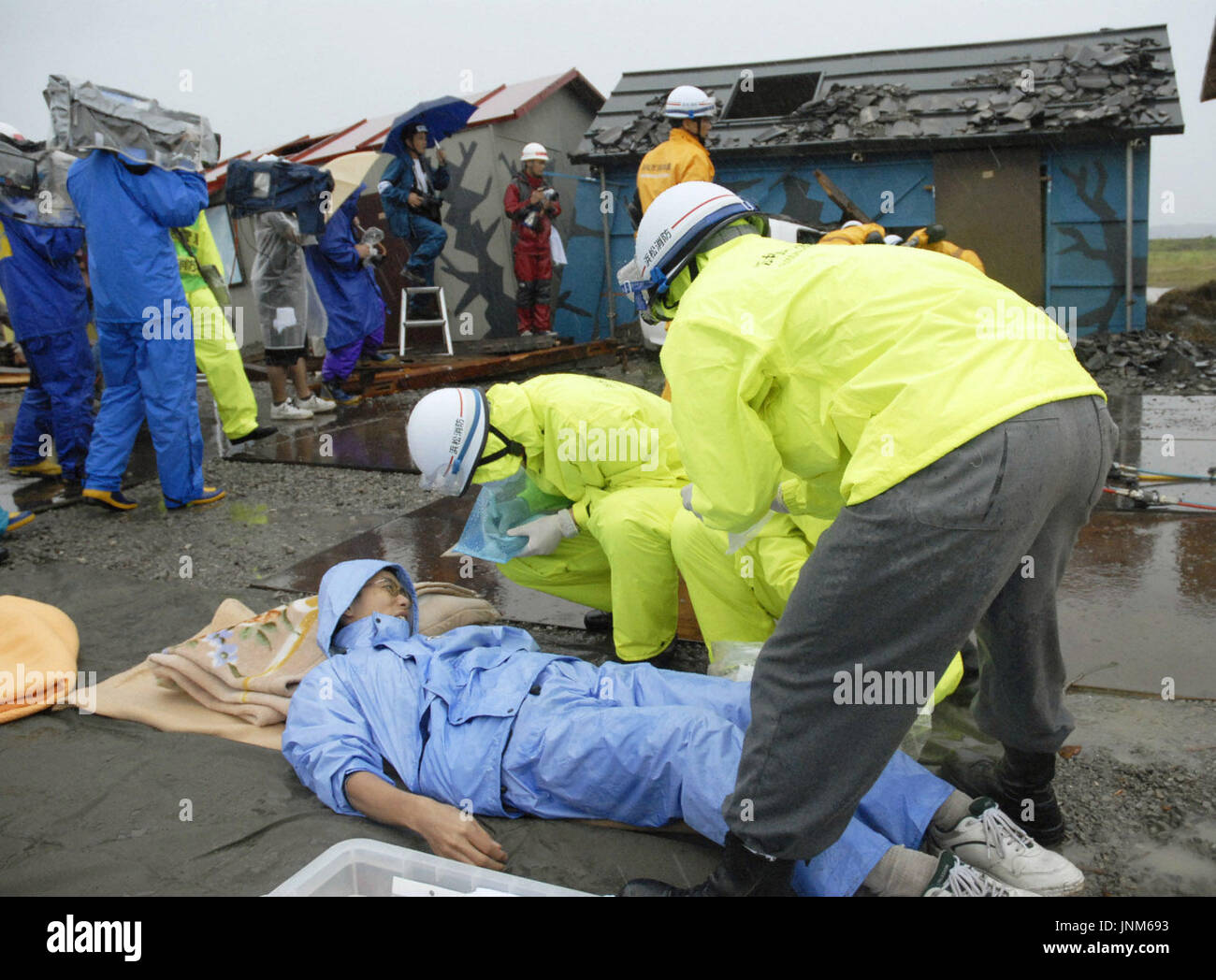 TOKYO, Japan - Firefighters rescue people from collapsed houses in ...