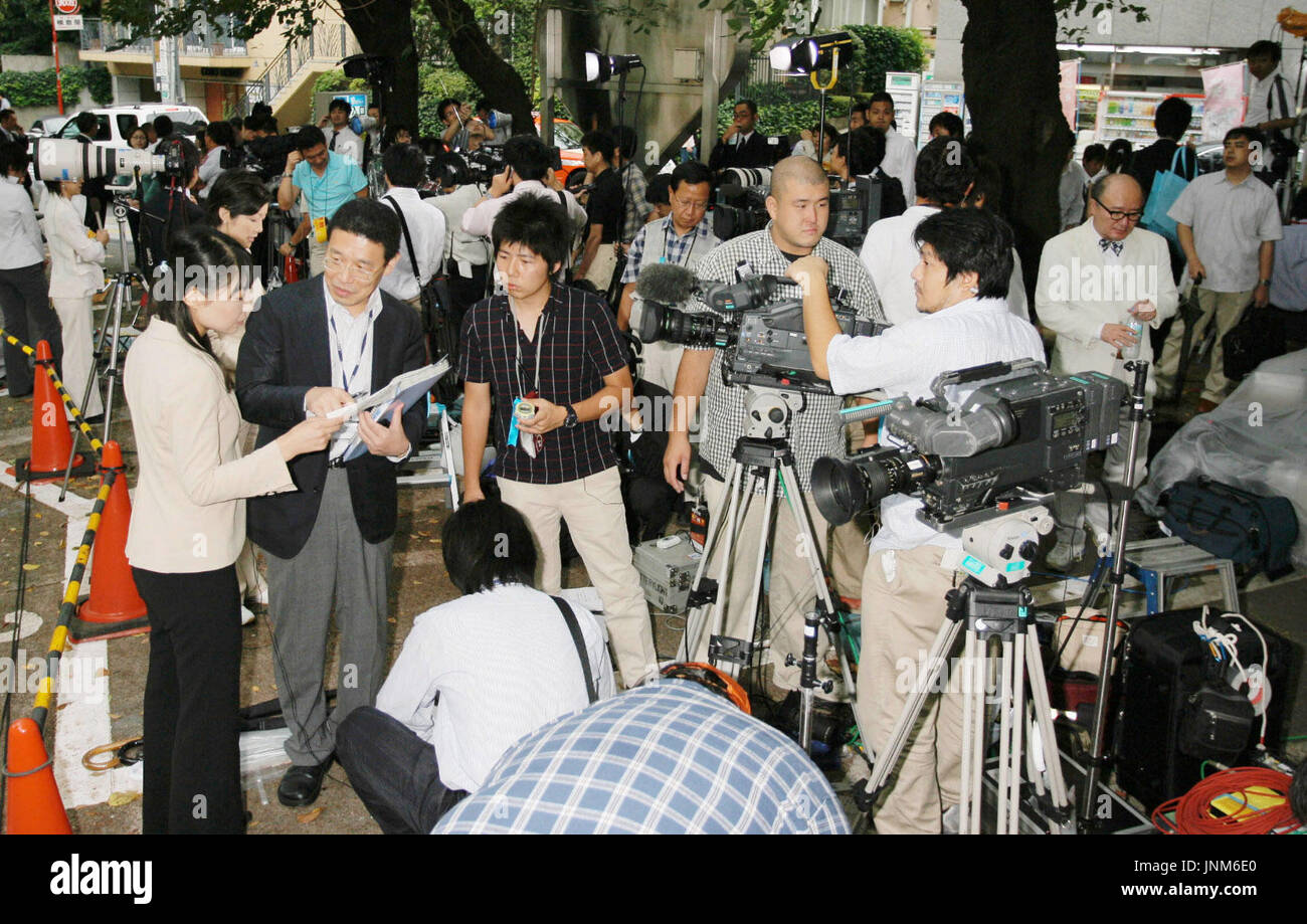 TOKYO, Japan - Journalists crowd the parking area outside Aiiku ...