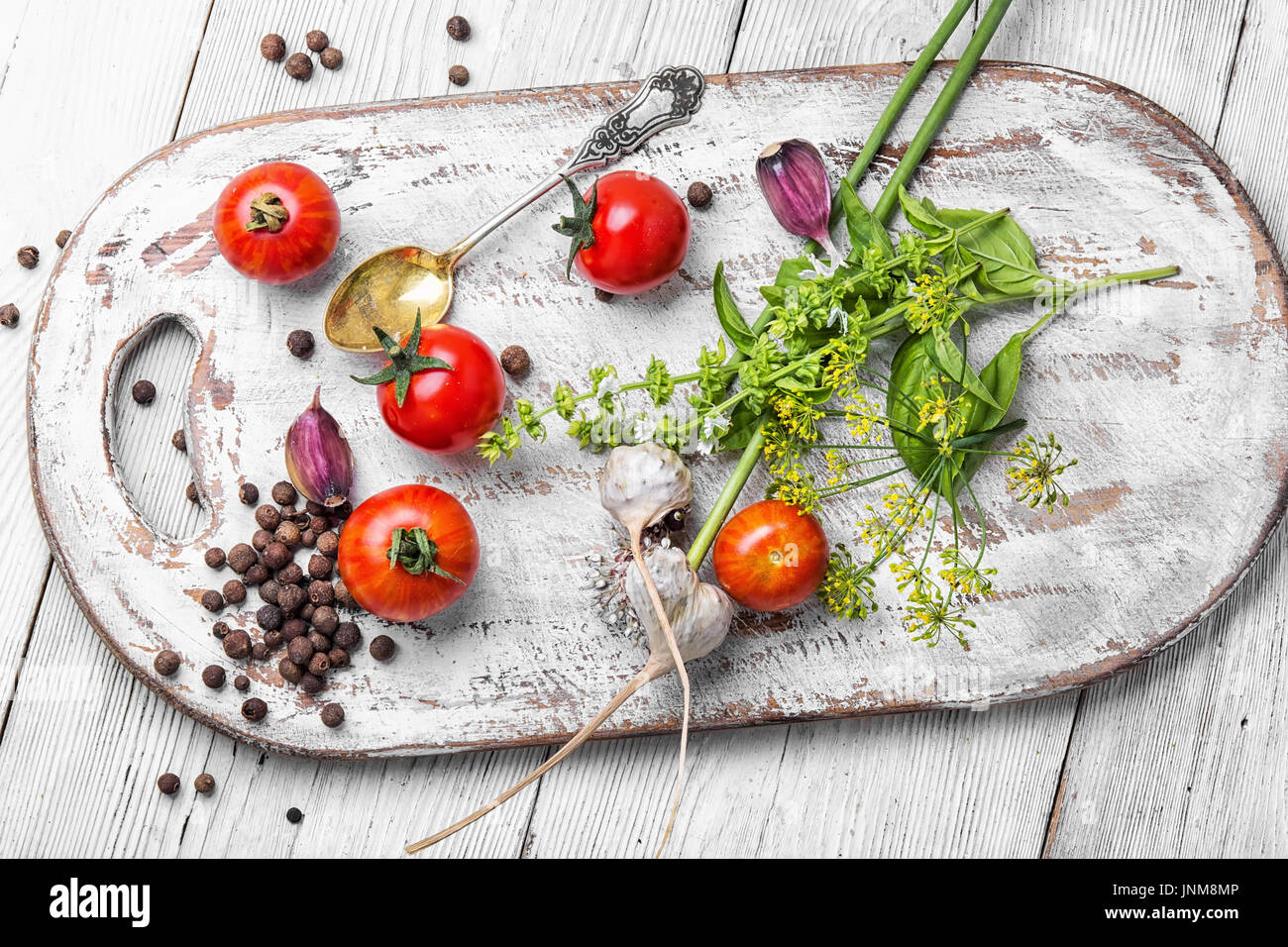 tomato,peppercorn and garlic for pickling on white kitchen board Stock ...