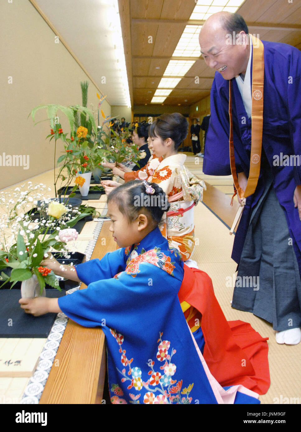 KYOTO, Japan - Flower arrangement leader Senei Ikenobo (R) looks at his followers arranging ...