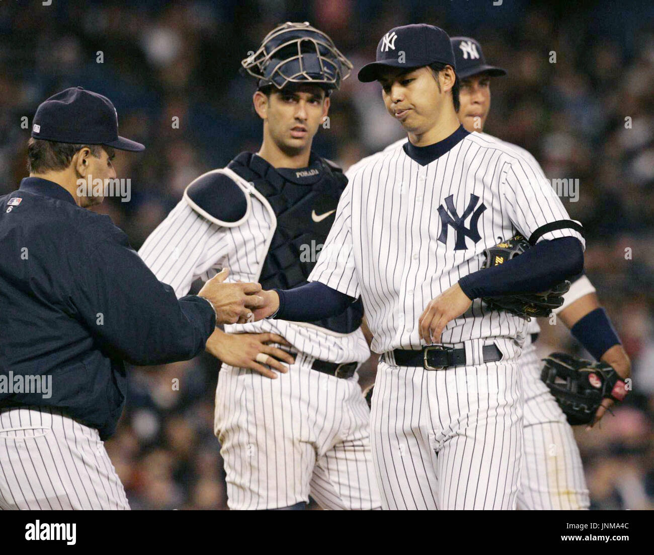 NEW YORK, United States - New York Yankees starter Kei Igawa (R) hands ...