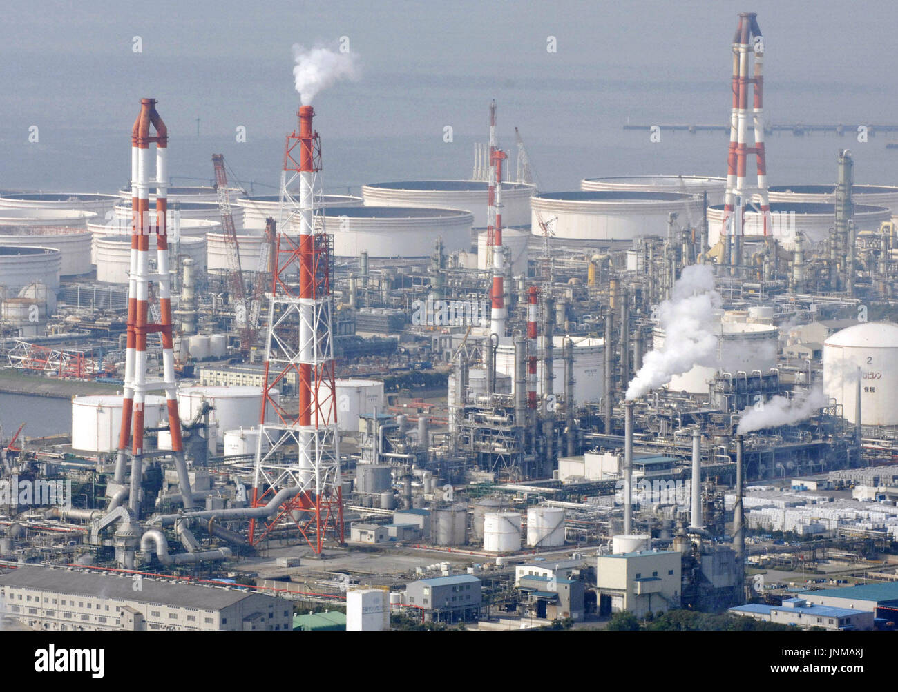 TOKYO, Japan - A heavy industry zone dotted with smoke stacks in ...